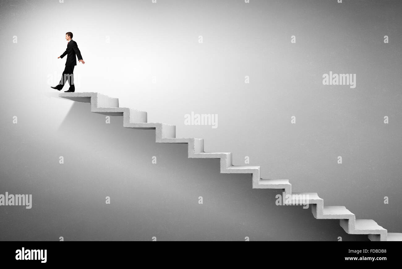 Young businessman walking up on staircase representing success concept ...