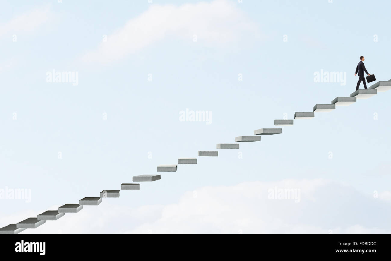 Young businessman walking up on staircase representing success concept ...