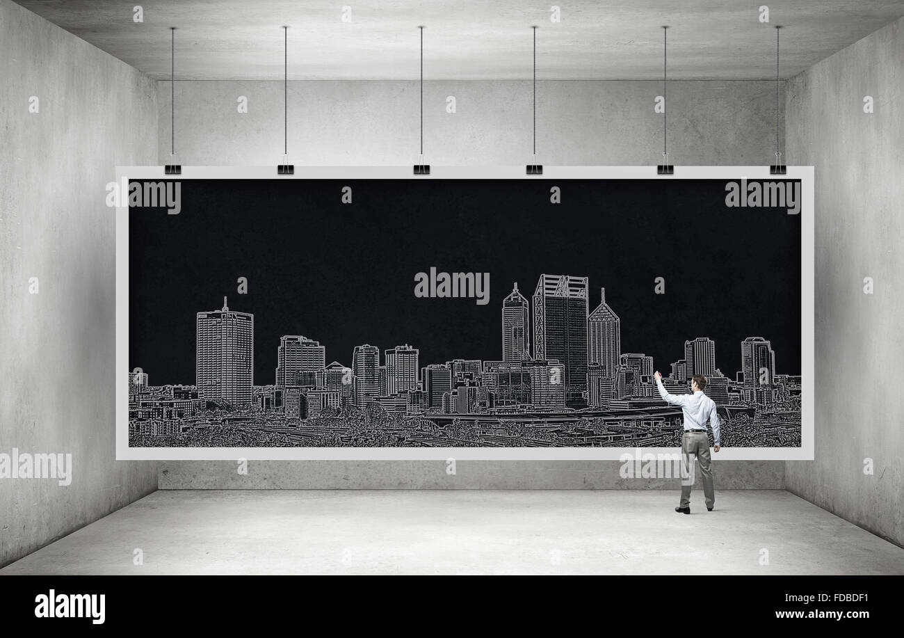 Rear view of man engineer drawing on chalkboard Stock Photo - Alamy