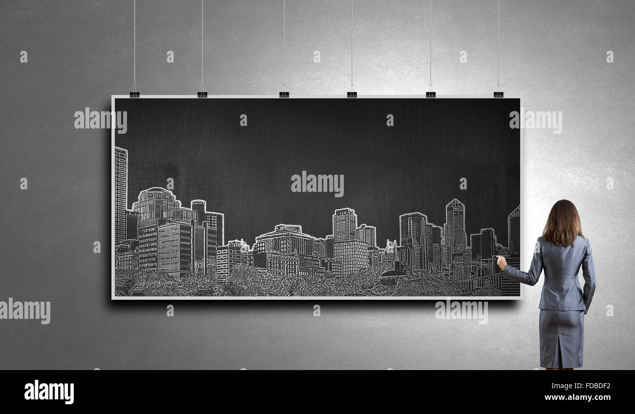 Rear view of woman engineer drawing on chalkboard Stock Photo - Alamy