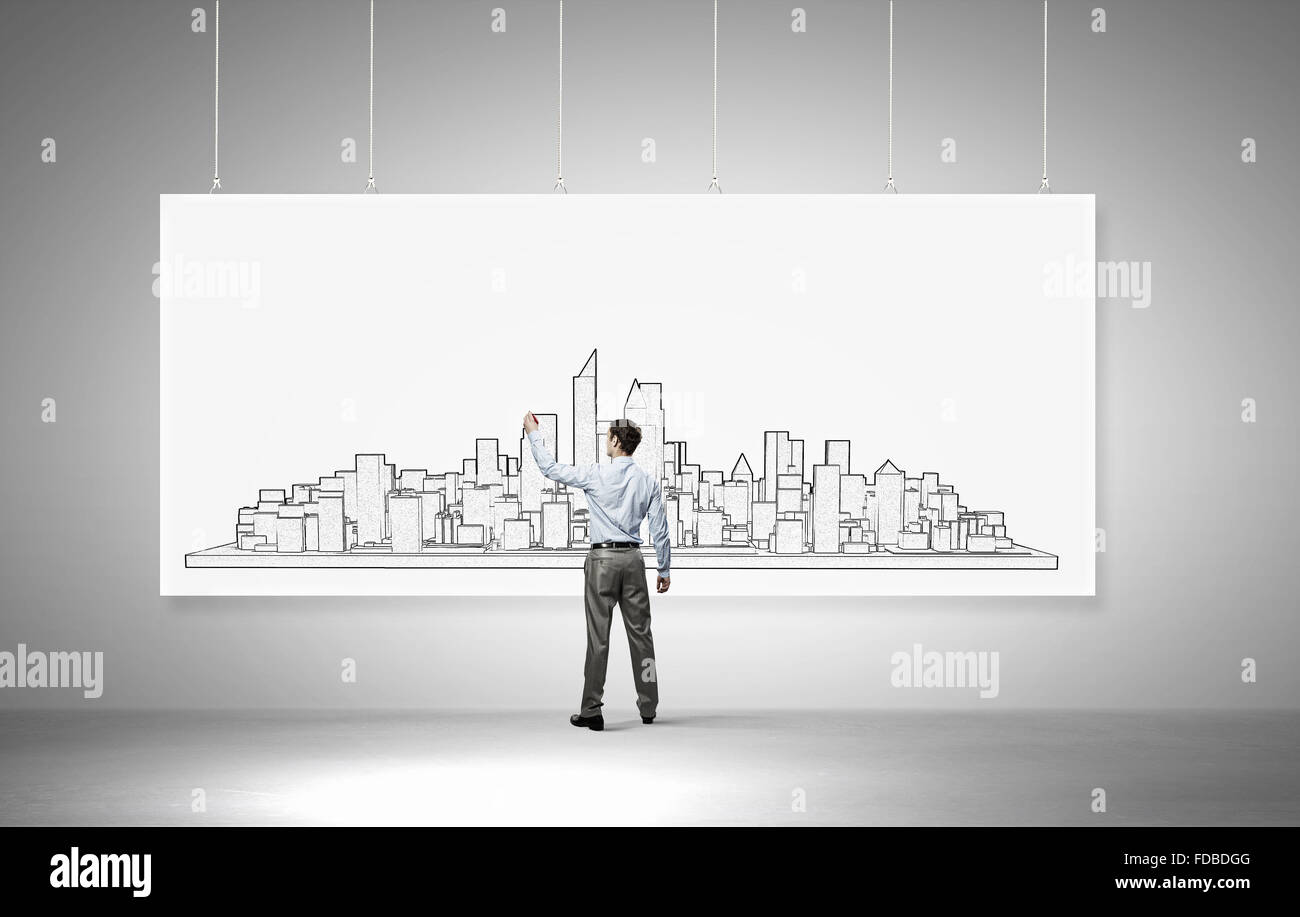 Rear view of builder man drawing construction project on white banner ...