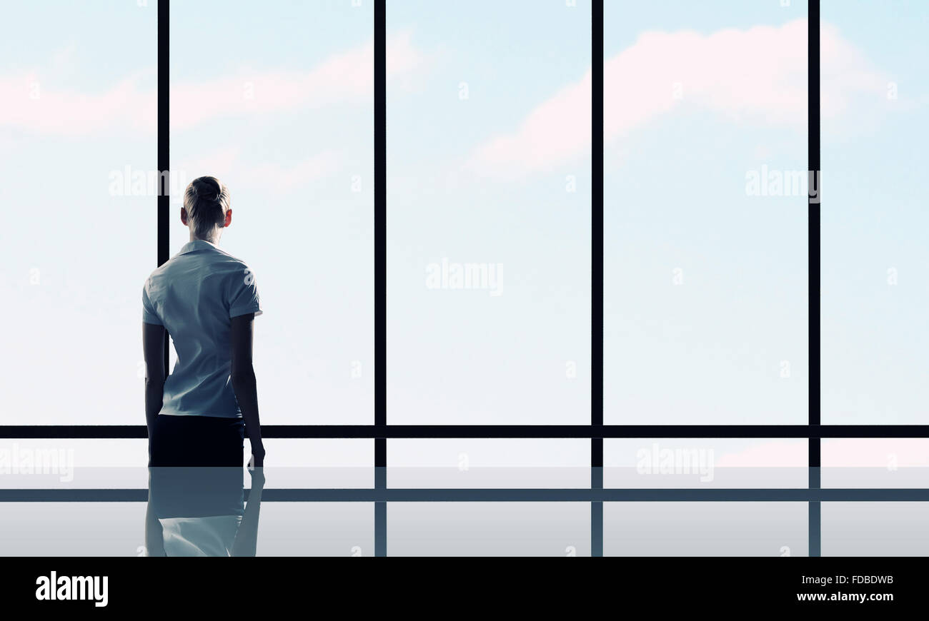 Back view of businesswoman looking in office window Stock Photo - Alamy