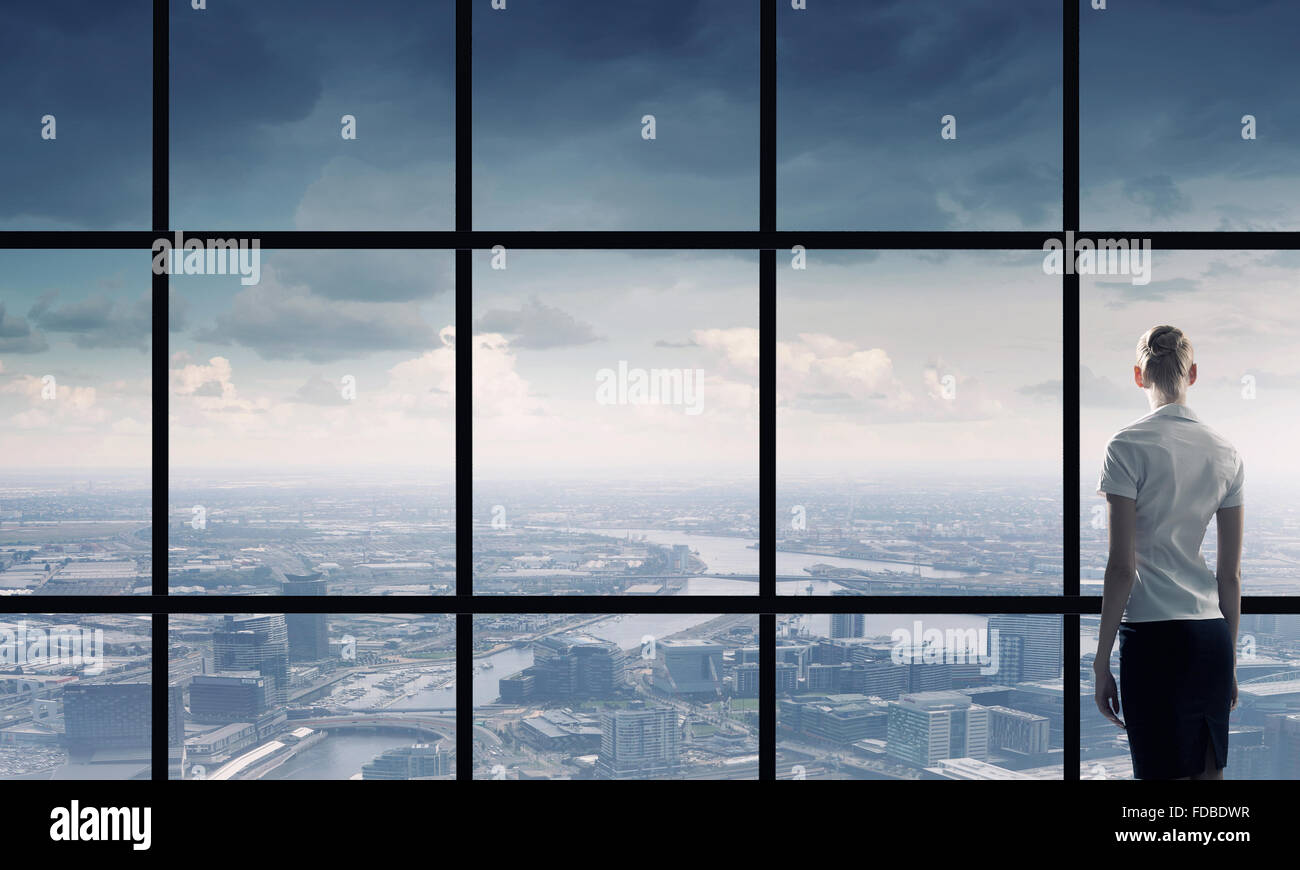 Back view of businesswoman looking in office window Stock Photo - Alamy