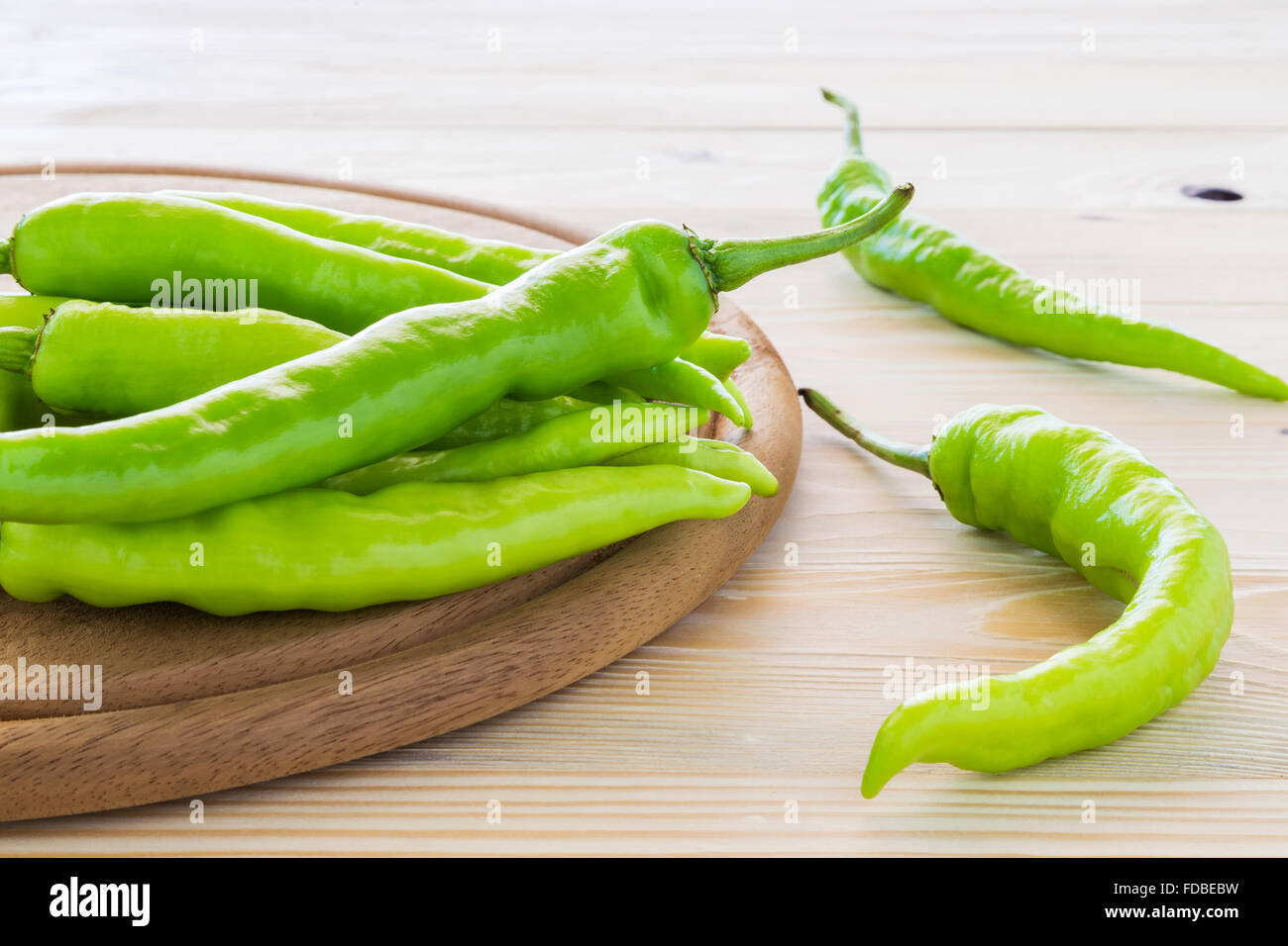 Green peppers placed on the chopping block for cooking Stock Photo - Alamy