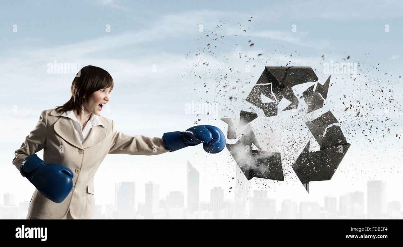 Young businesswoman in blue boxing gloves breaking recycle sign Stock ...