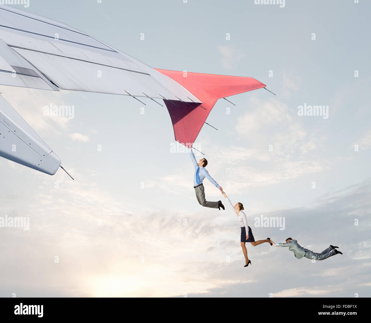 Young businessmen flying on edge of airplane wing Stock Photo - Alamy