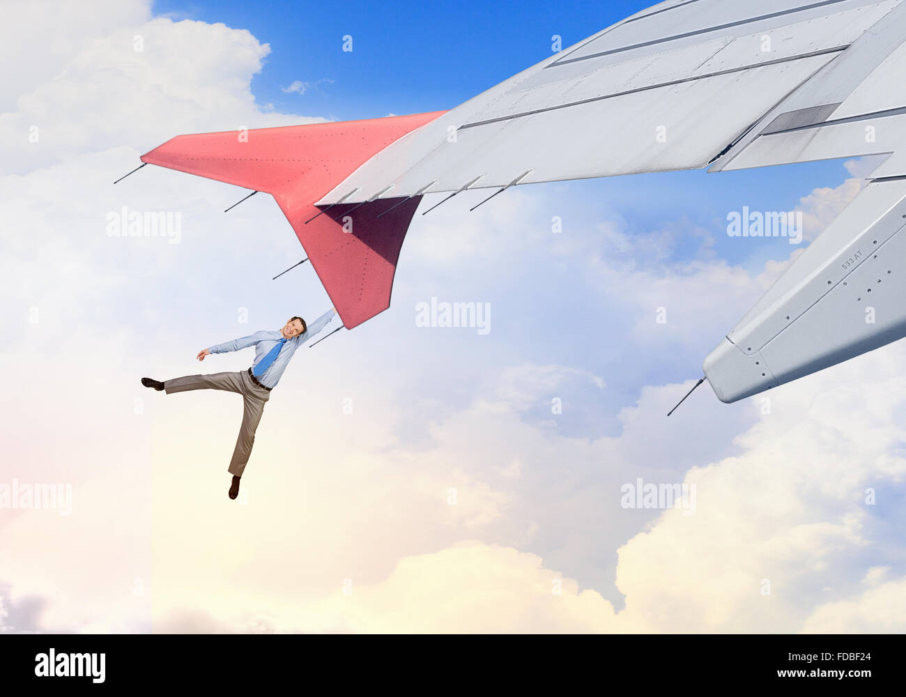 Young businessman flying on edge of airplane wing Stock Photo - Alamy
