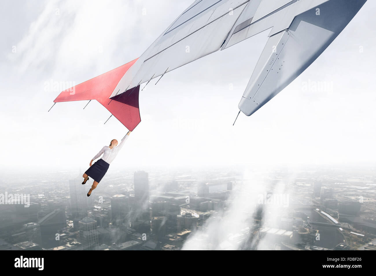 Young businesswoman flying on edge of airplane wing Stock Photo - Alamy