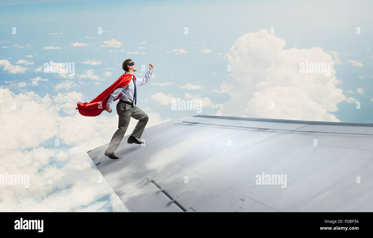 Young businessman standing on edge of airplane wing Stock Photo - Alamy
