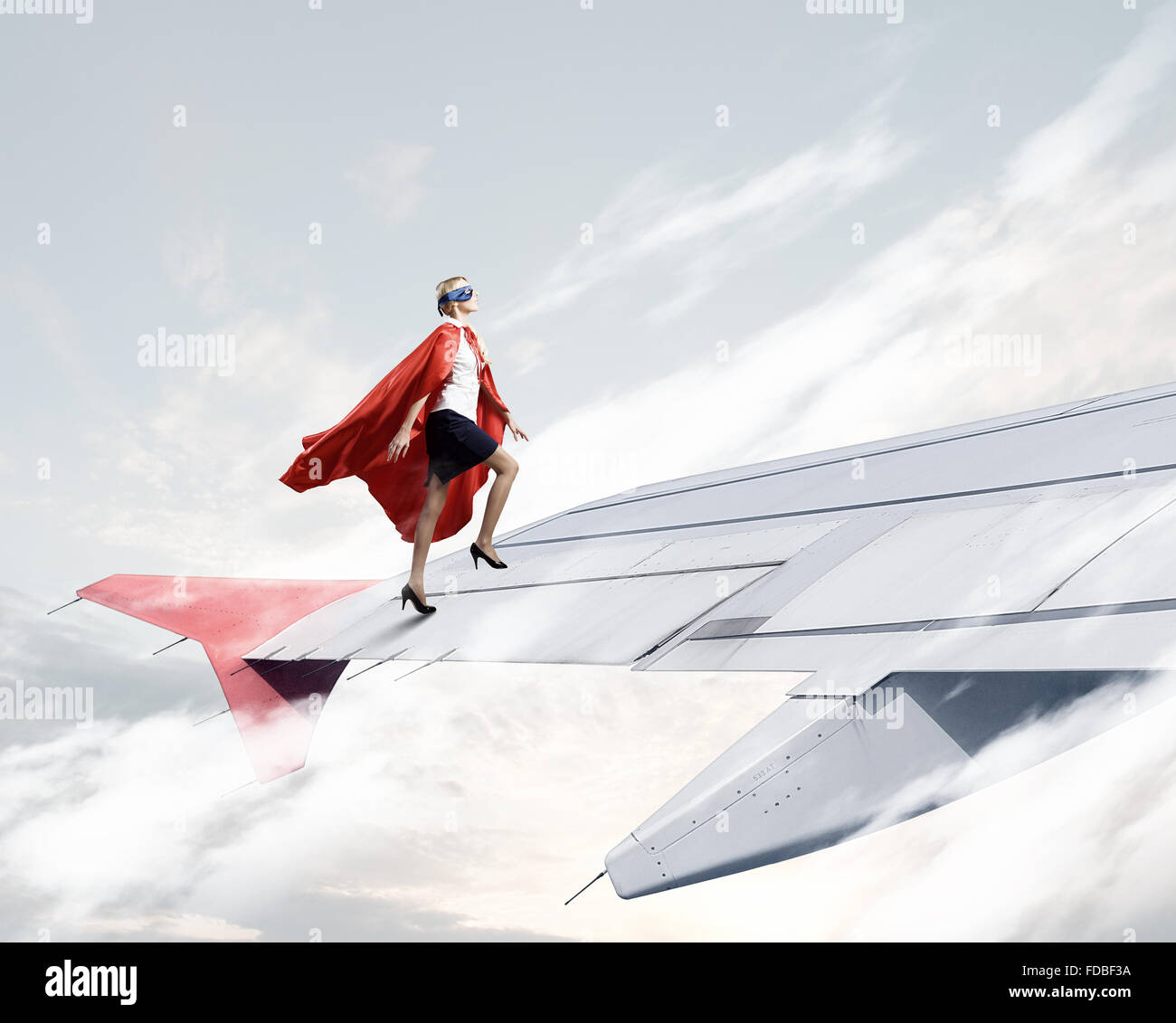 Young businesswoman standing on edge of airplane wing Stock Photo - Alamy