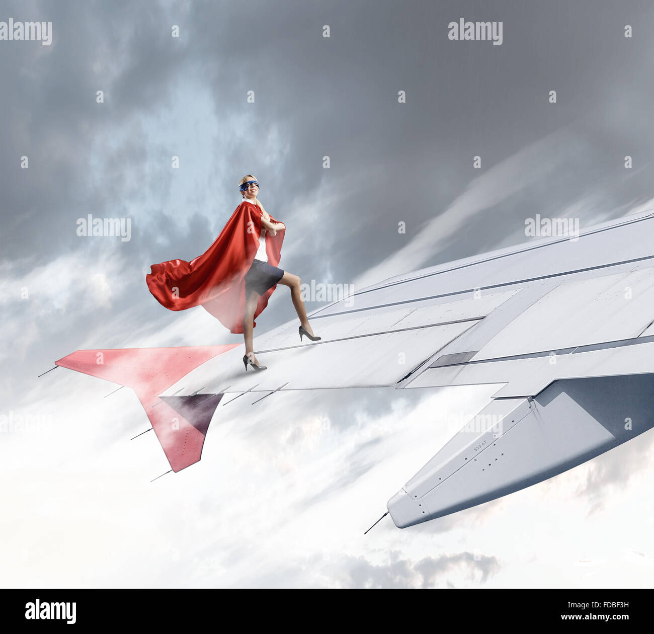 Young businesswoman standing on edge of airplane wing Stock Photo - Alamy