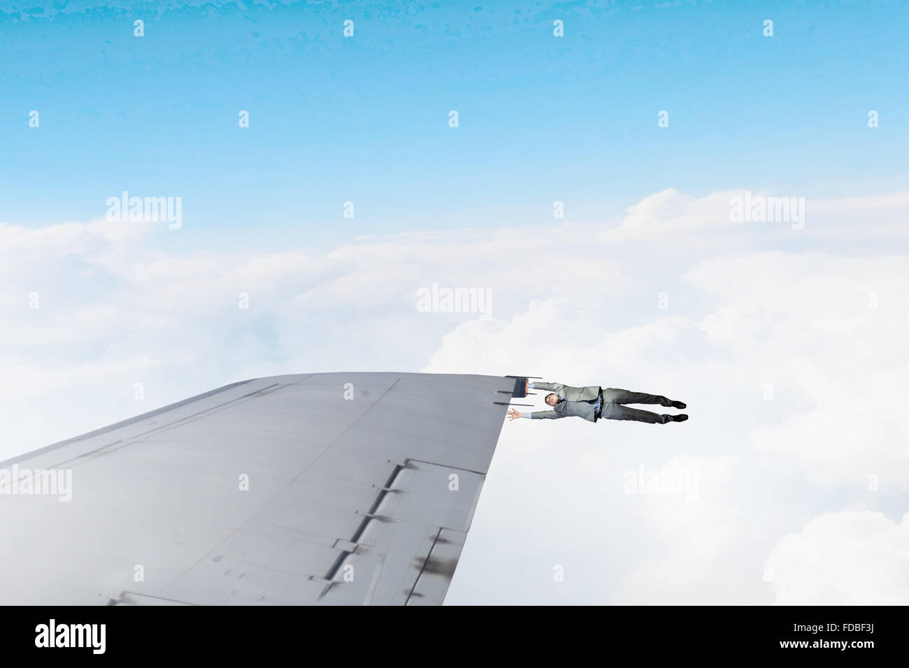 Young businessman flying on edge of airplane wing Stock Photo - Alamy