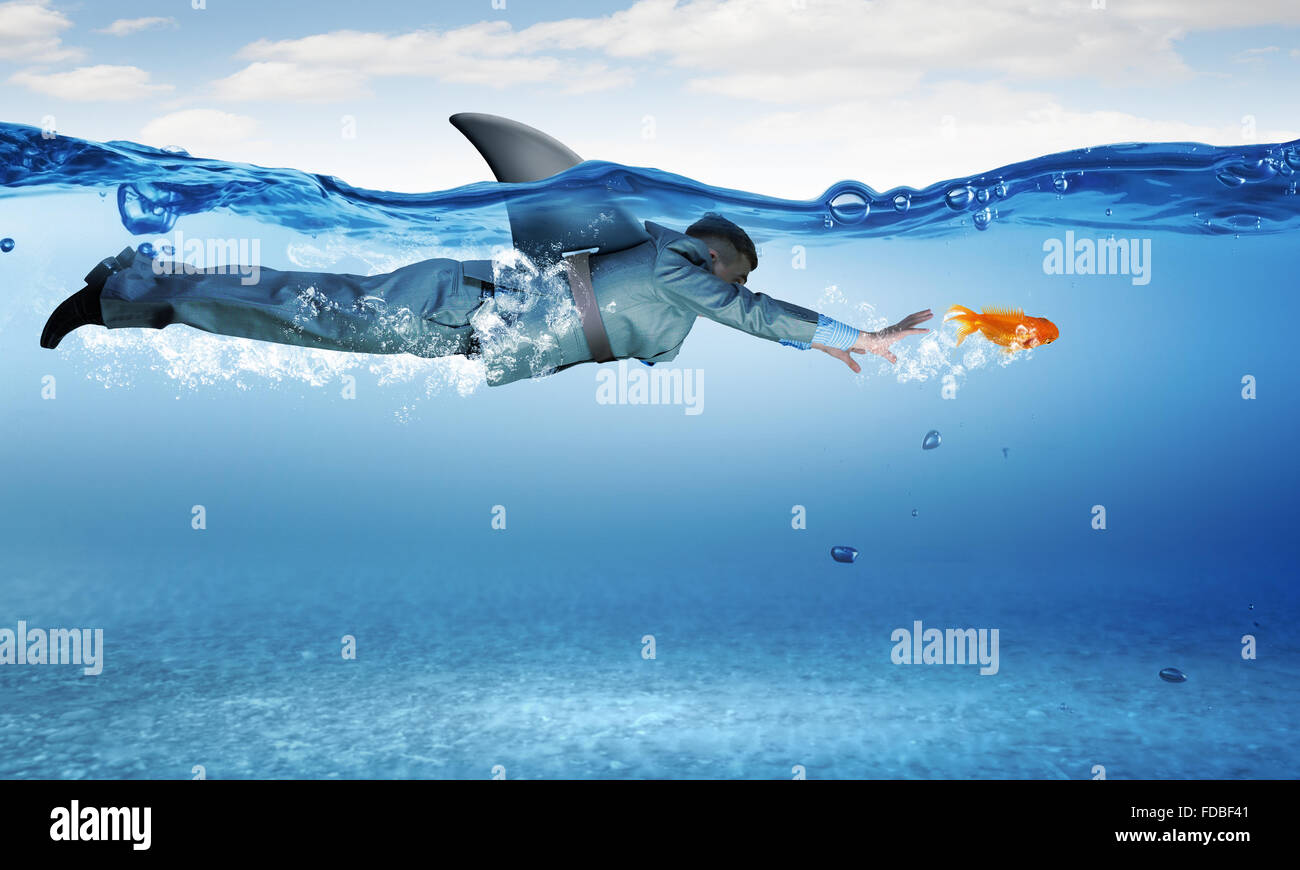 Young businessman with shark flipper swiming under water Stock Photo - Alamy