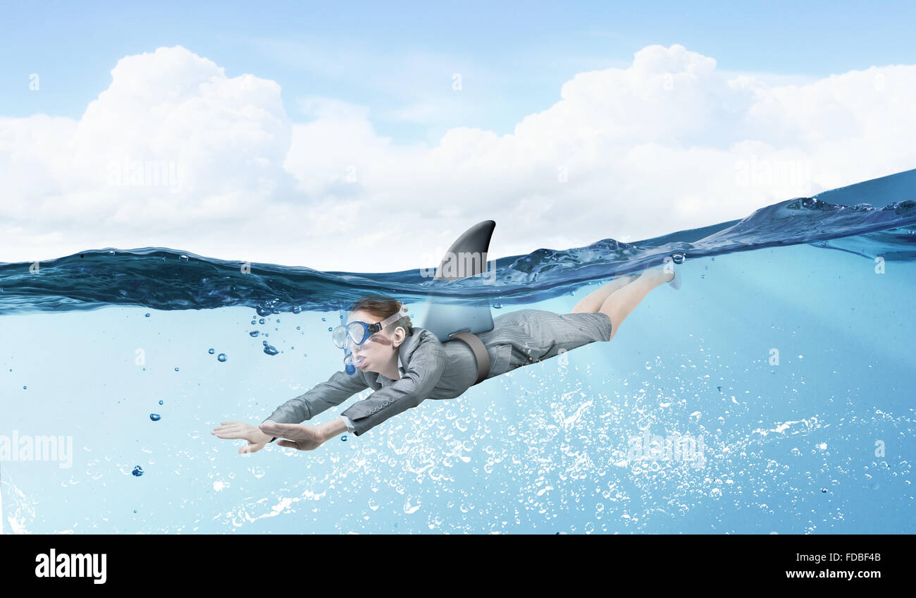 Young businesswoman with shark flipper swiming under water Stock Photo - Alamy