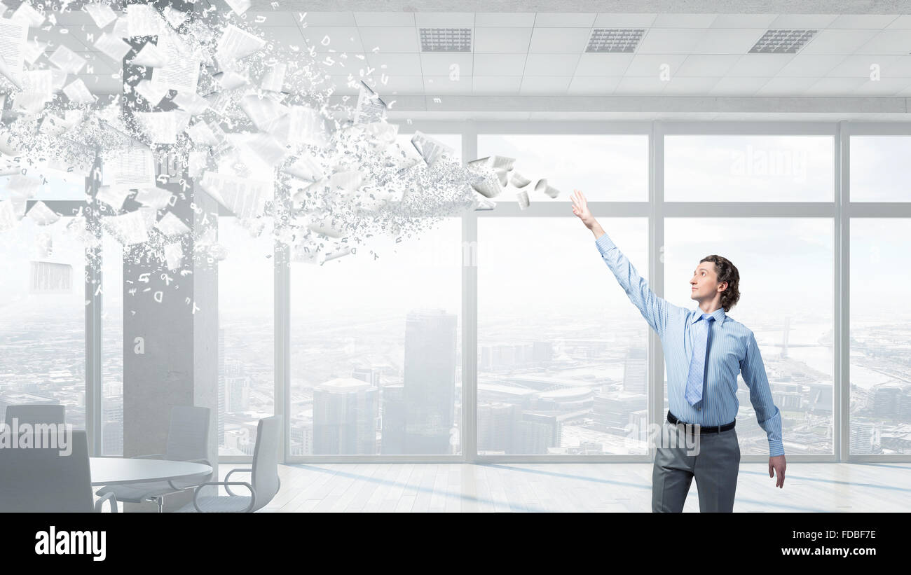Businessman controlling paper documents flying in air Stock Photo - Alamy