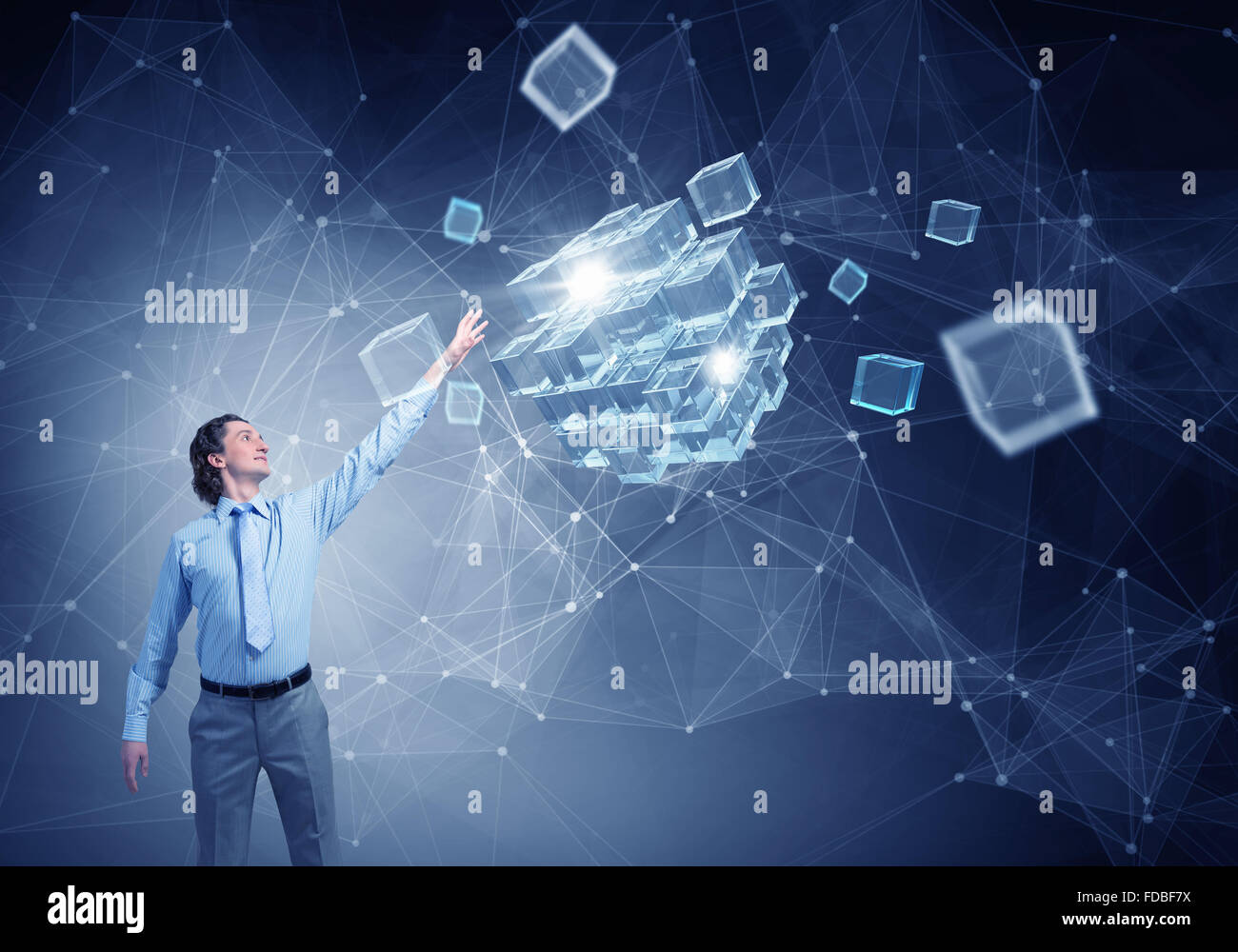 Businessman reaching hand to touch digital cube figure Stock Photo - Alamy