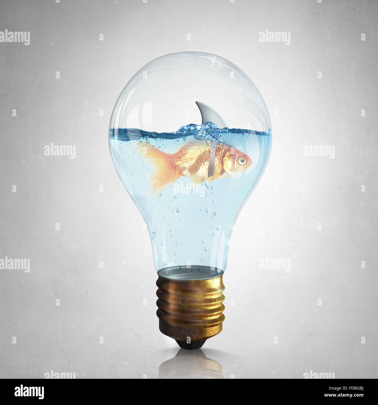 Little goldfish in light bulb wearing shark fin Stock Photo - Alamy