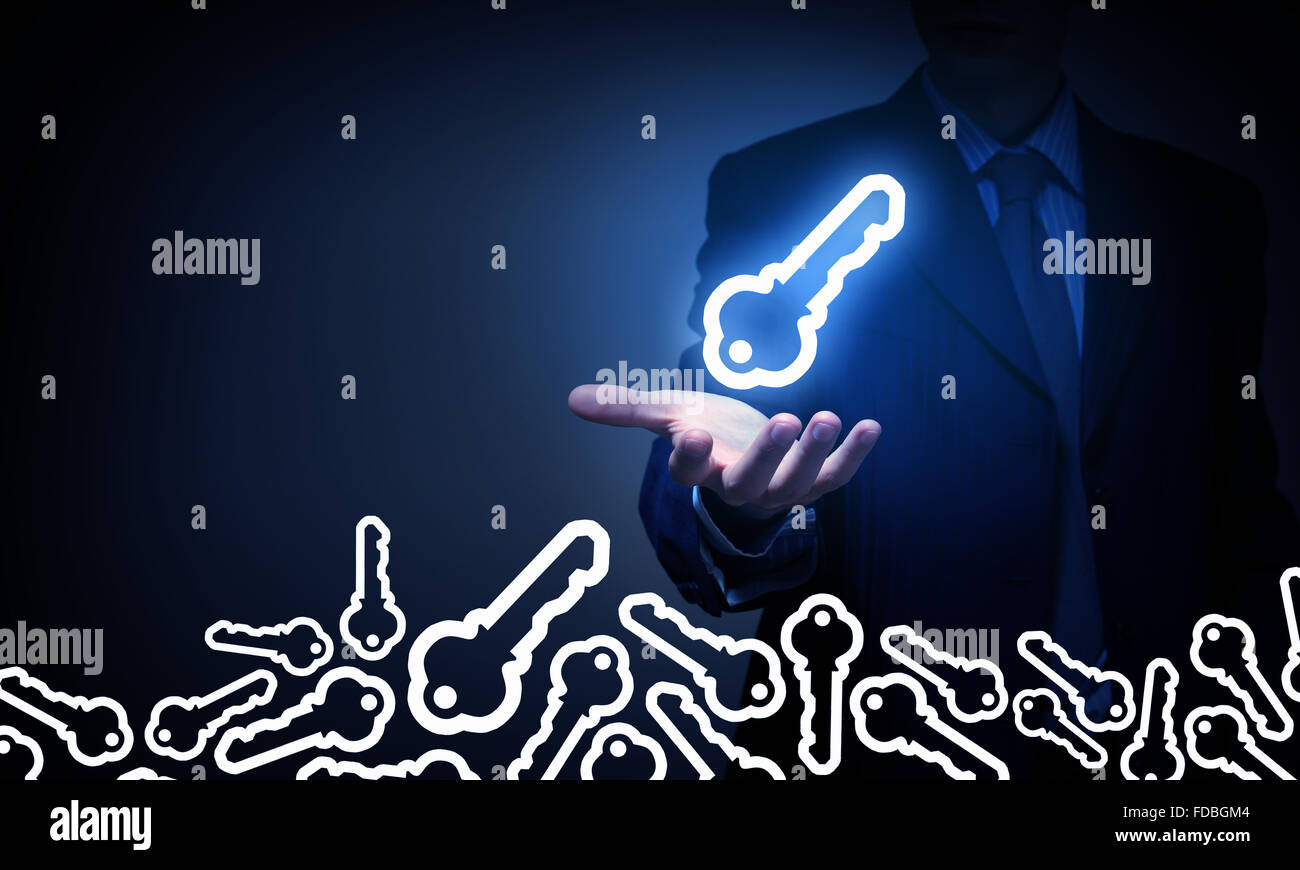 Male hand holding key glowing sign in palms Stock Photo - Alamy
