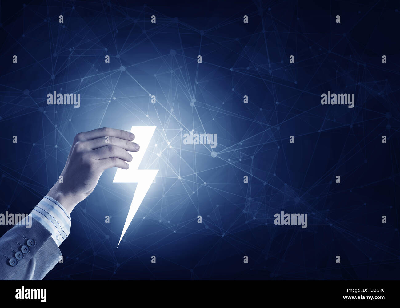 Hand of businessman on dark background holding glowing thunderbolt ...