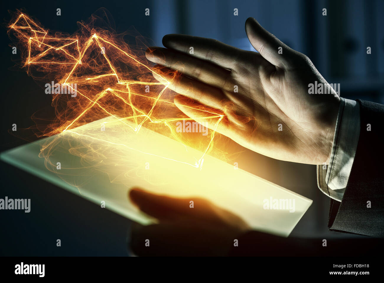 Glowing light email symbol on dark background Stock Photo - Alamy