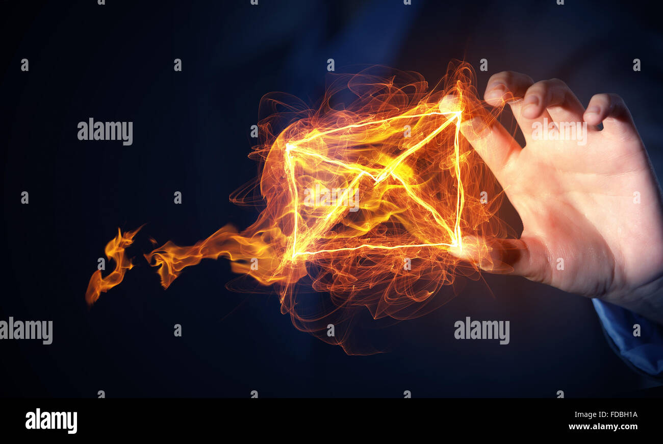 Glowing light email symbol on dark background Stock Photo - Alamy
