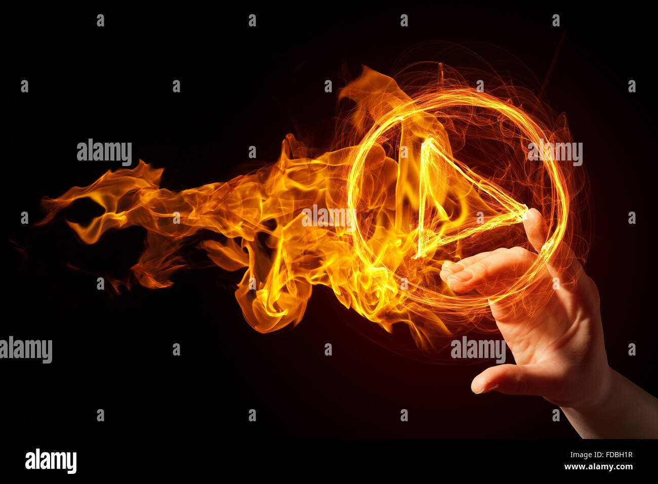 Finger touch glowing fire play icon on dark background Stock Photo - Alamy