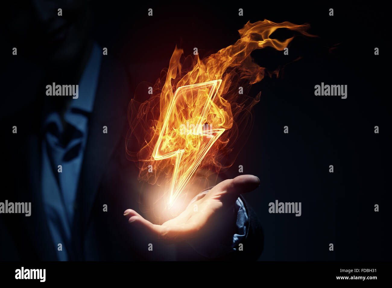 Glowing power lightning icon in palm on dark background Stock Photo - Alamy