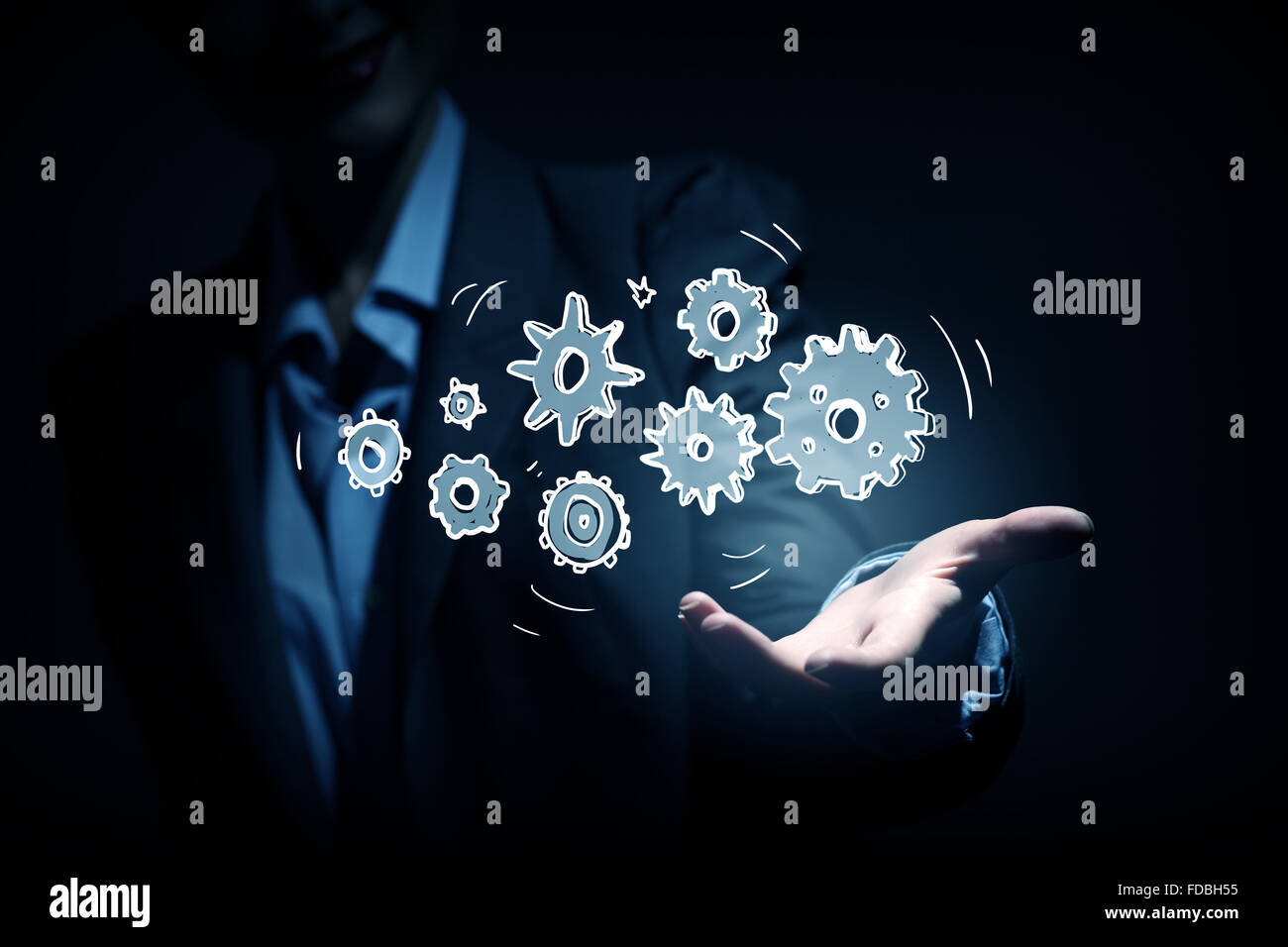 Business person hand holding gear mechanism representing interaction ...