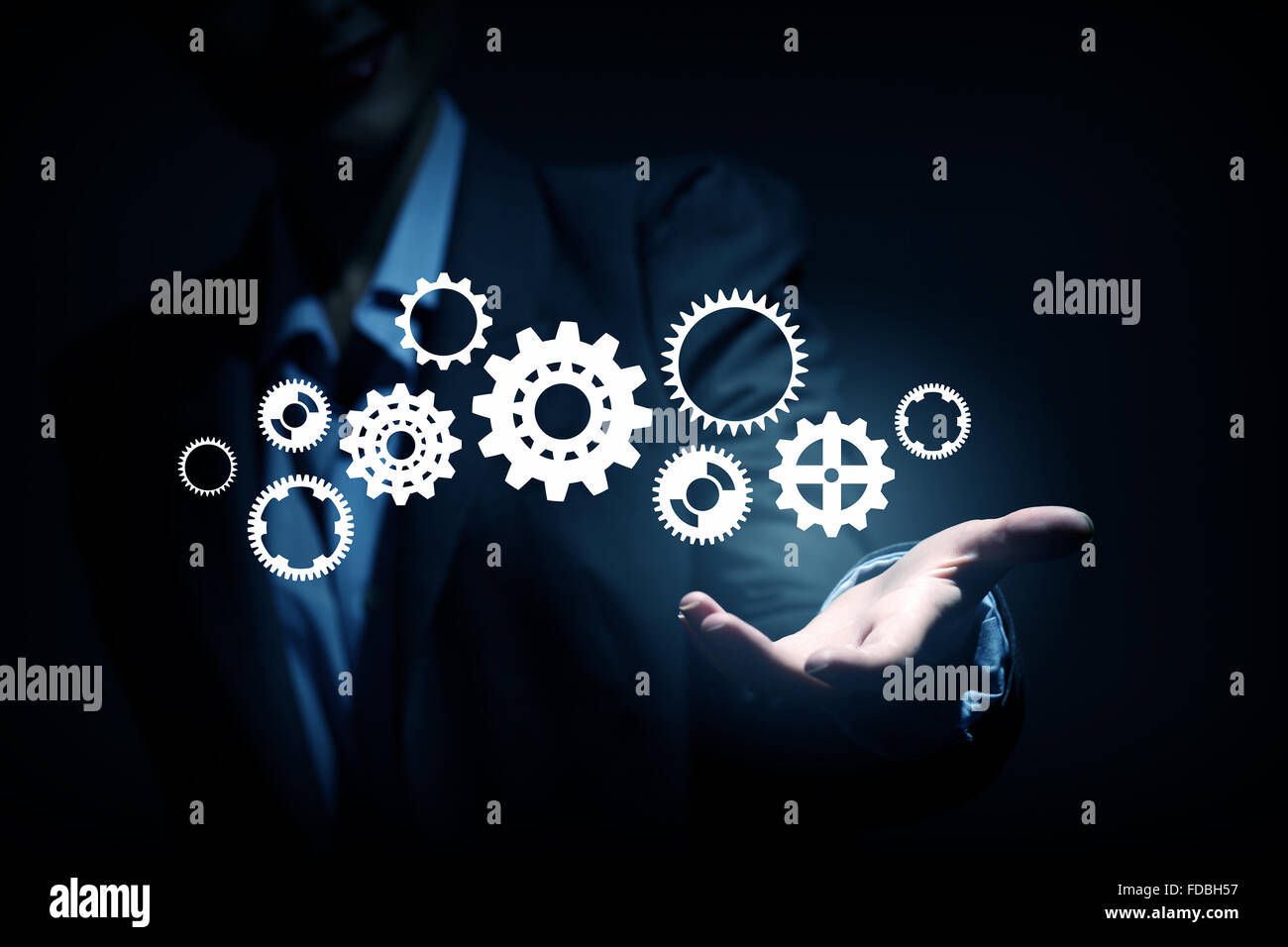 Business person hand holding gear mechanism representing interaction ...