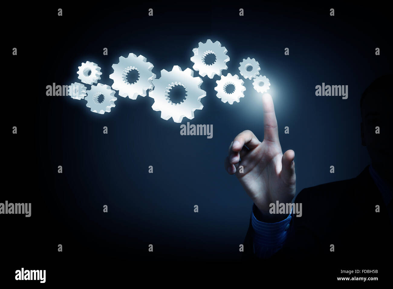 Business person hand touching gear mechanism representing interaction ...
