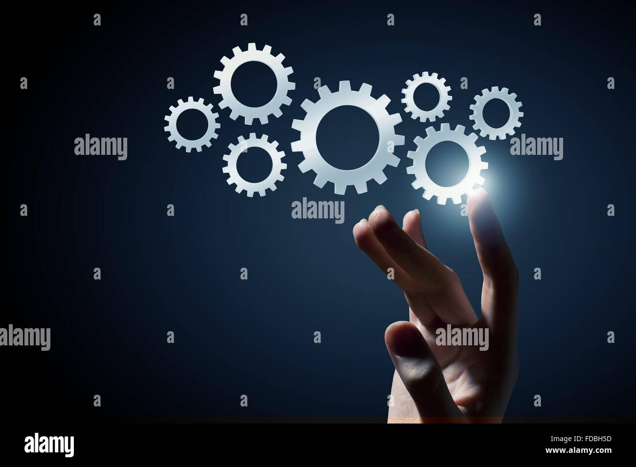 Business person hand touching gear mechanism representing interaction ...