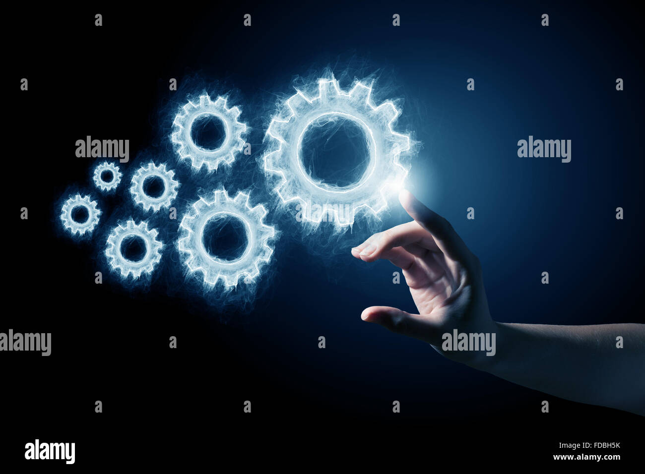 Business person hand touching gear mechanism representing interaction ...
