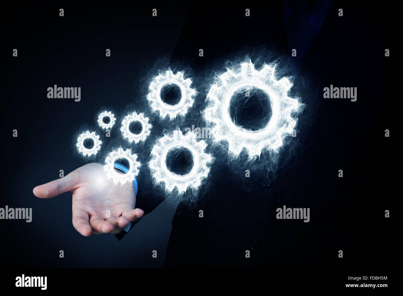 Business person hand holding gear mechanism representing interaction ...