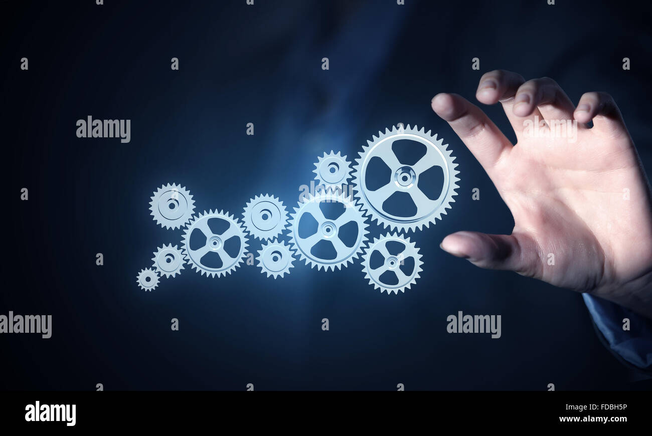 Business person hand touching gear mechanism representing interaction ...