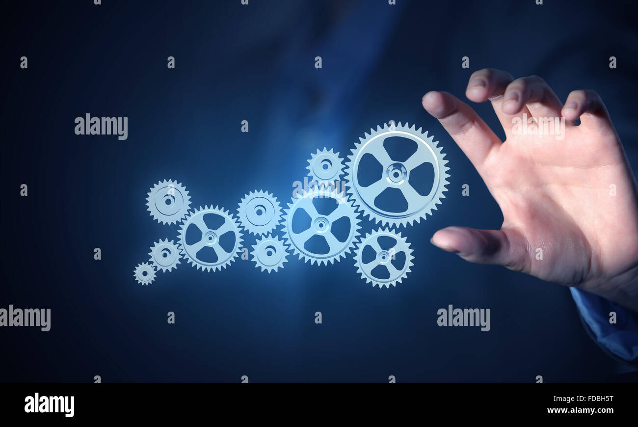 Business person hand touching gear mechanism representing interaction ...