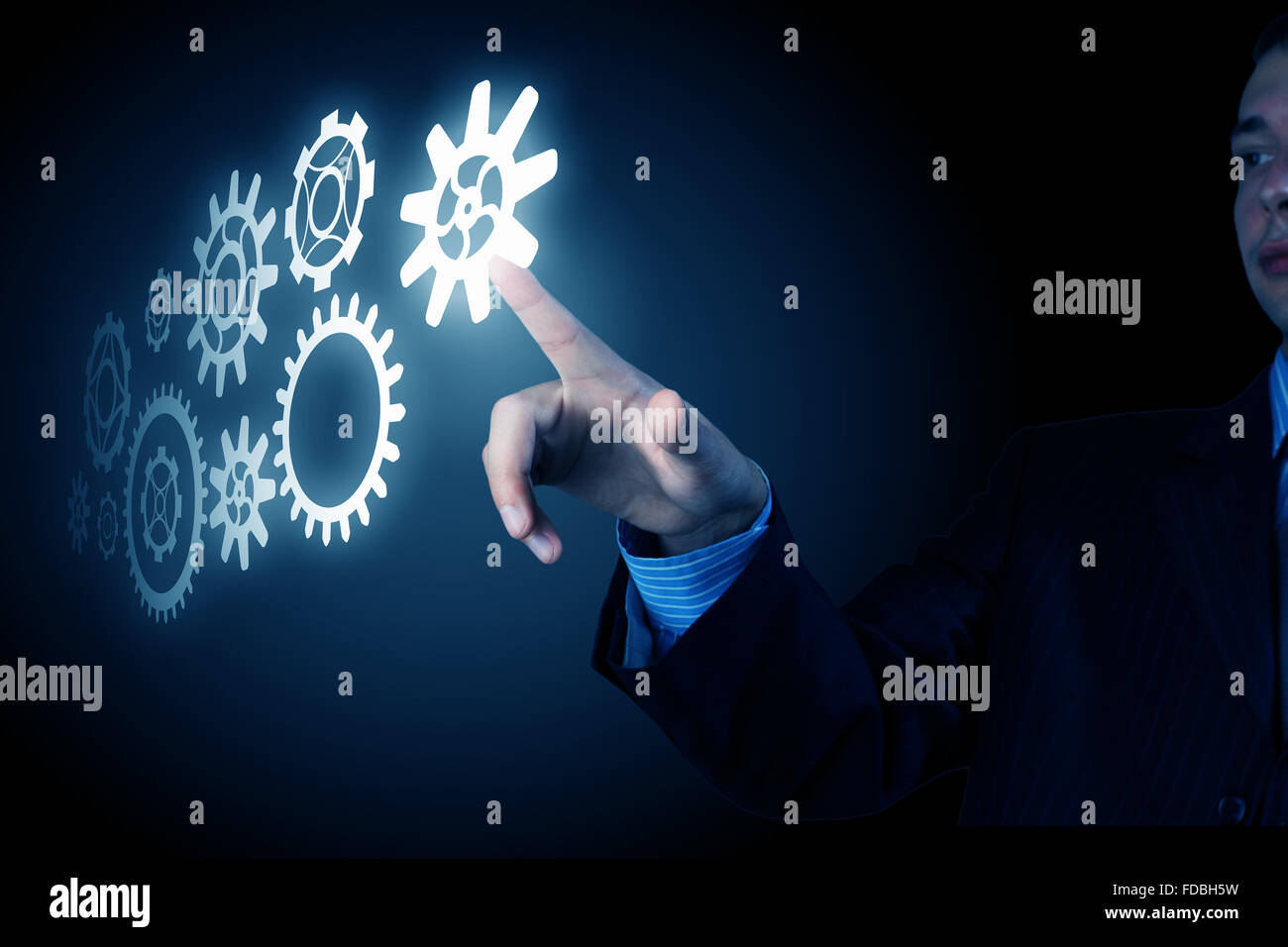 Business person hand touching gear mechanism representing interaction ...