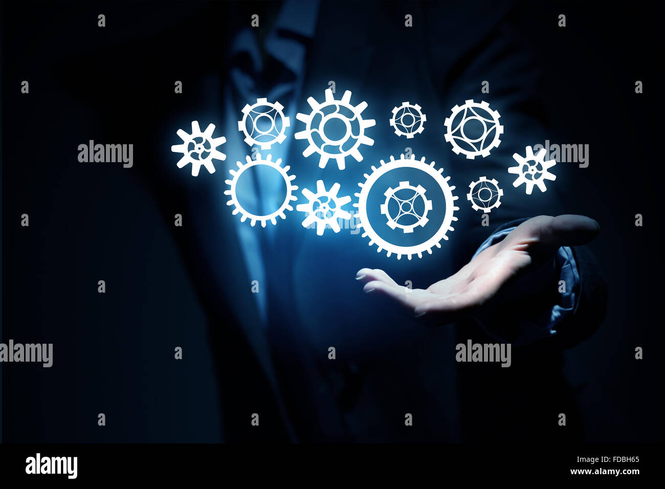 Business person hand touching gear mechanism representing interaction ...