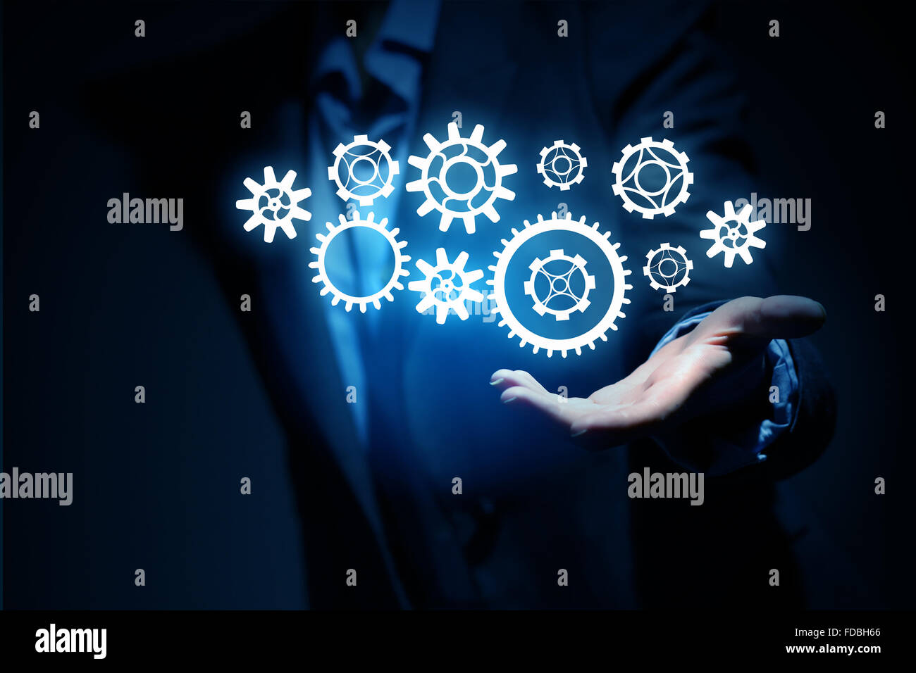 Business person hand touching gear mechanism representing interaction ...
