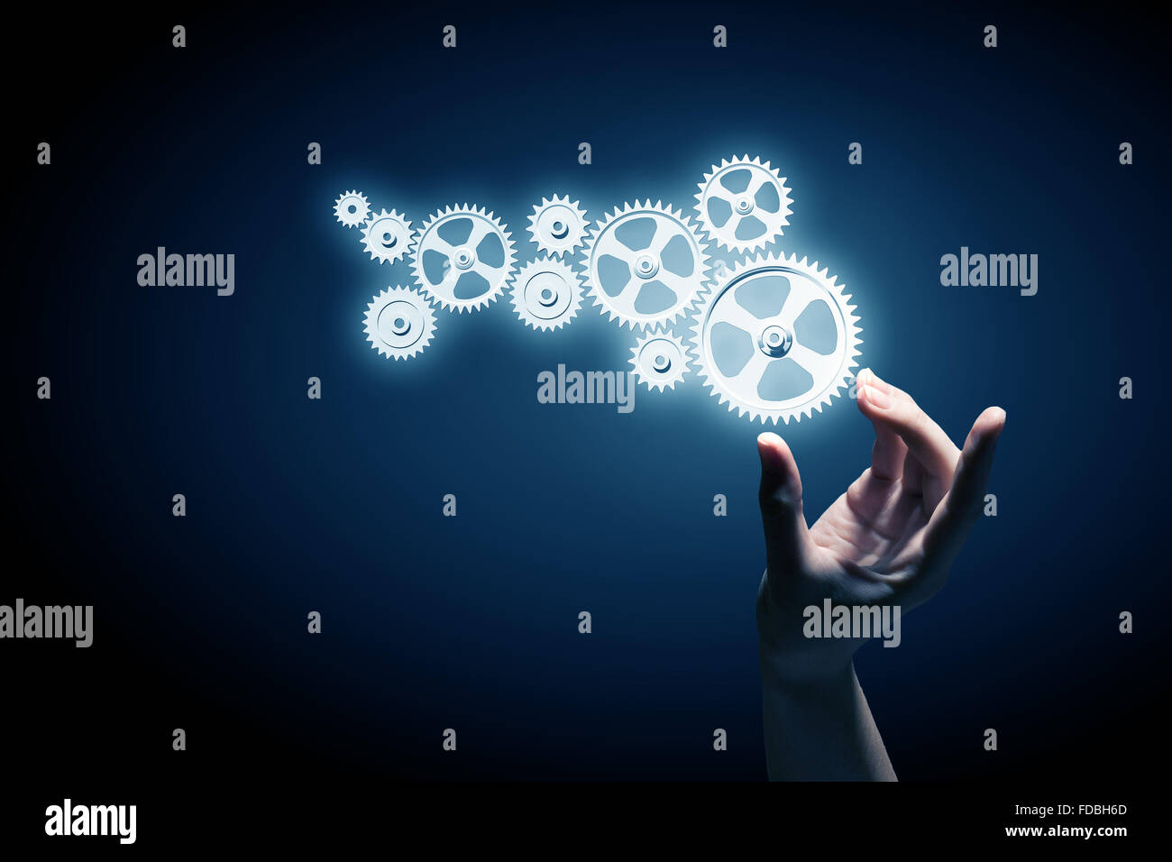 Business person hand touching gear mechanism representing interaction ...