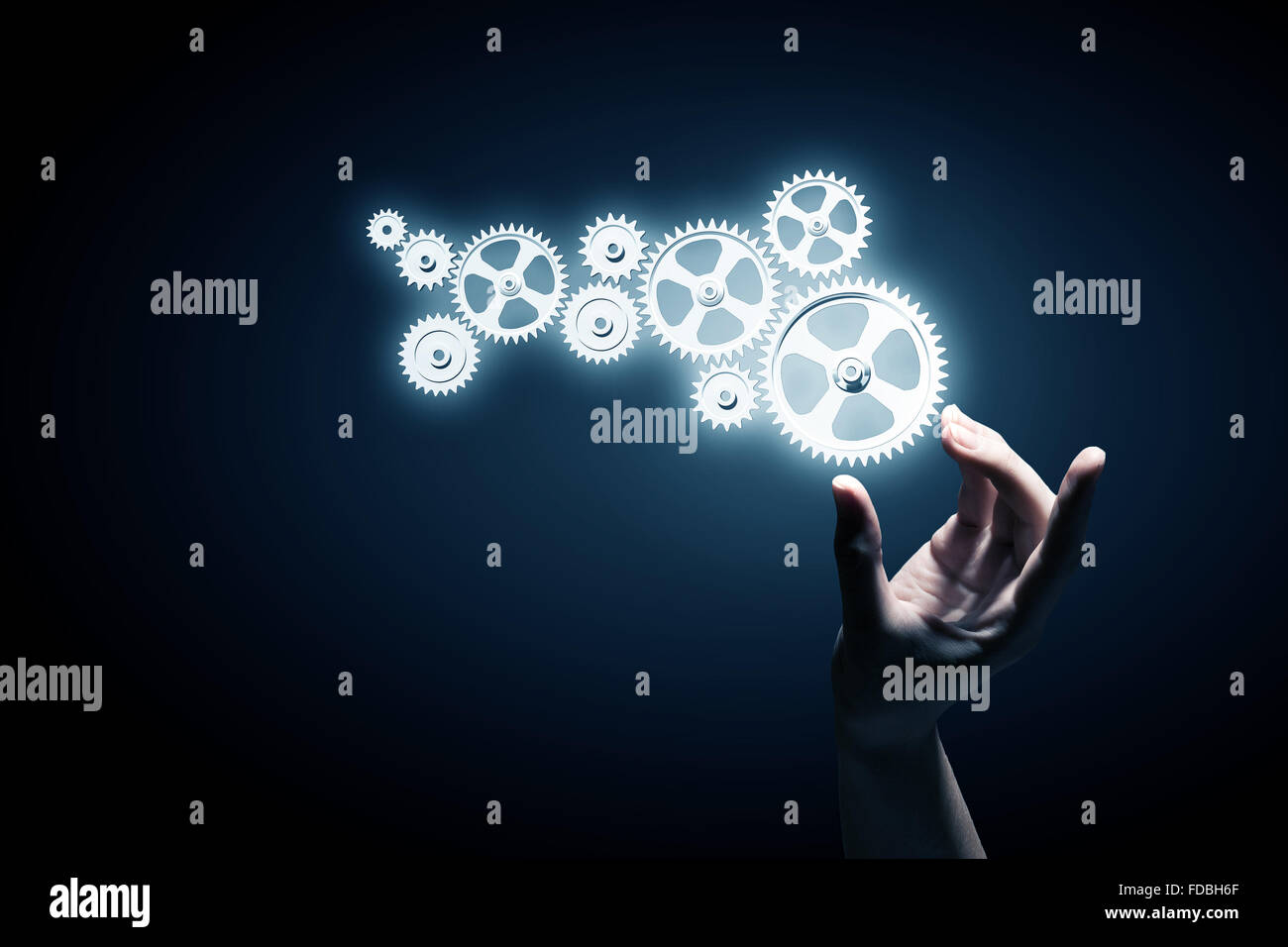 Business person hand touching gear mechanism representing interaction ...