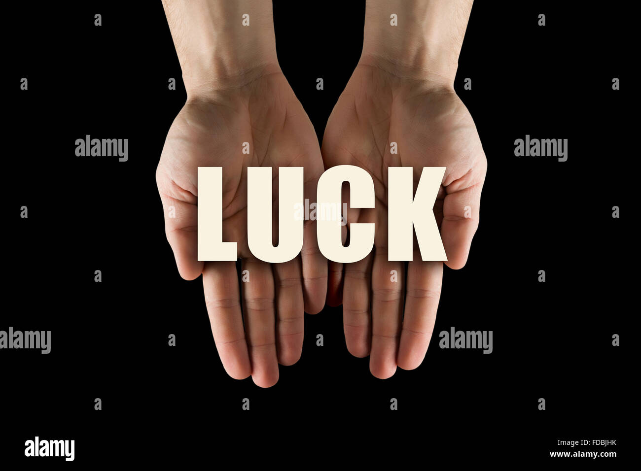 Male hands on dark background showing in palms word luck Stock Photo ...