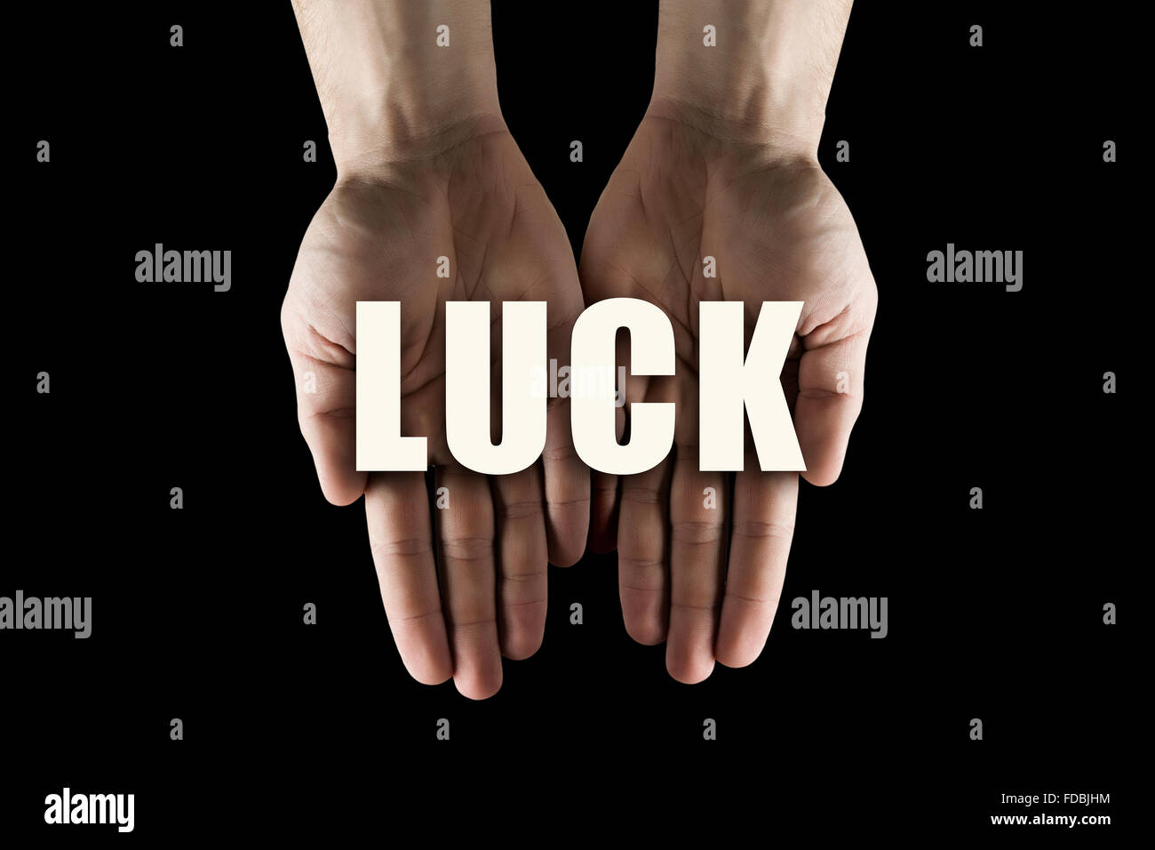 Male hands on dark background showing in palms word luck Stock Photo ...