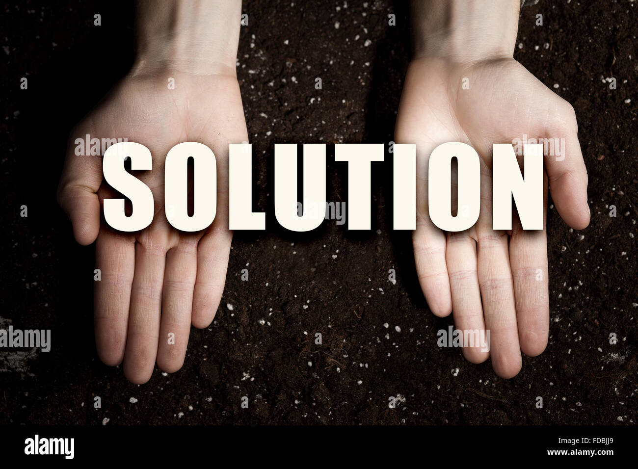 Male hands on soil background showing in palms idea word solution Stock ...