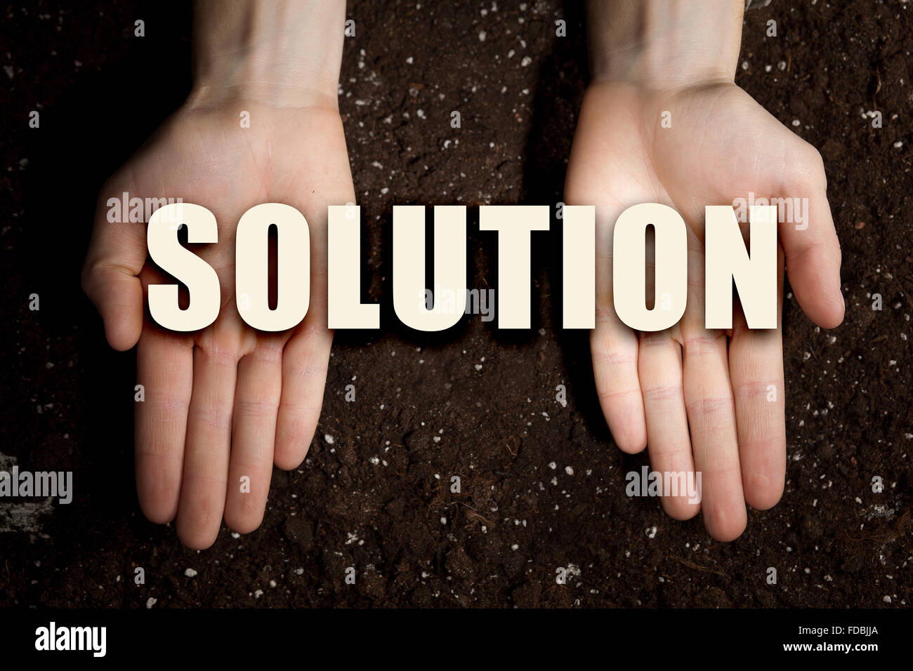 Male hands on soil background showing in palms idea word solution Stock ...