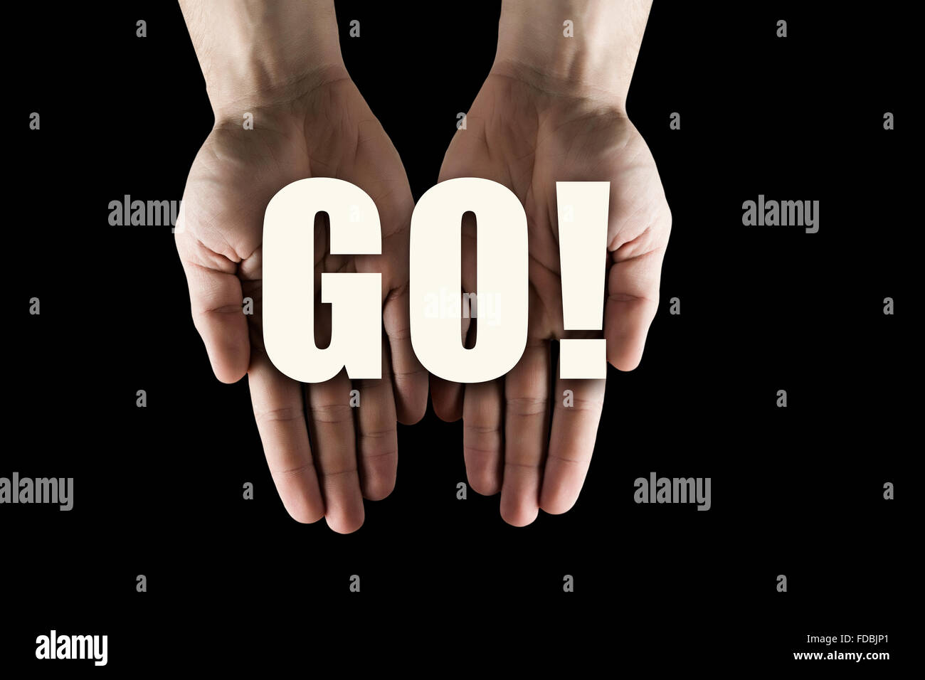 Male hands on dark background showing in palms word GO Stock Photo - Alamy