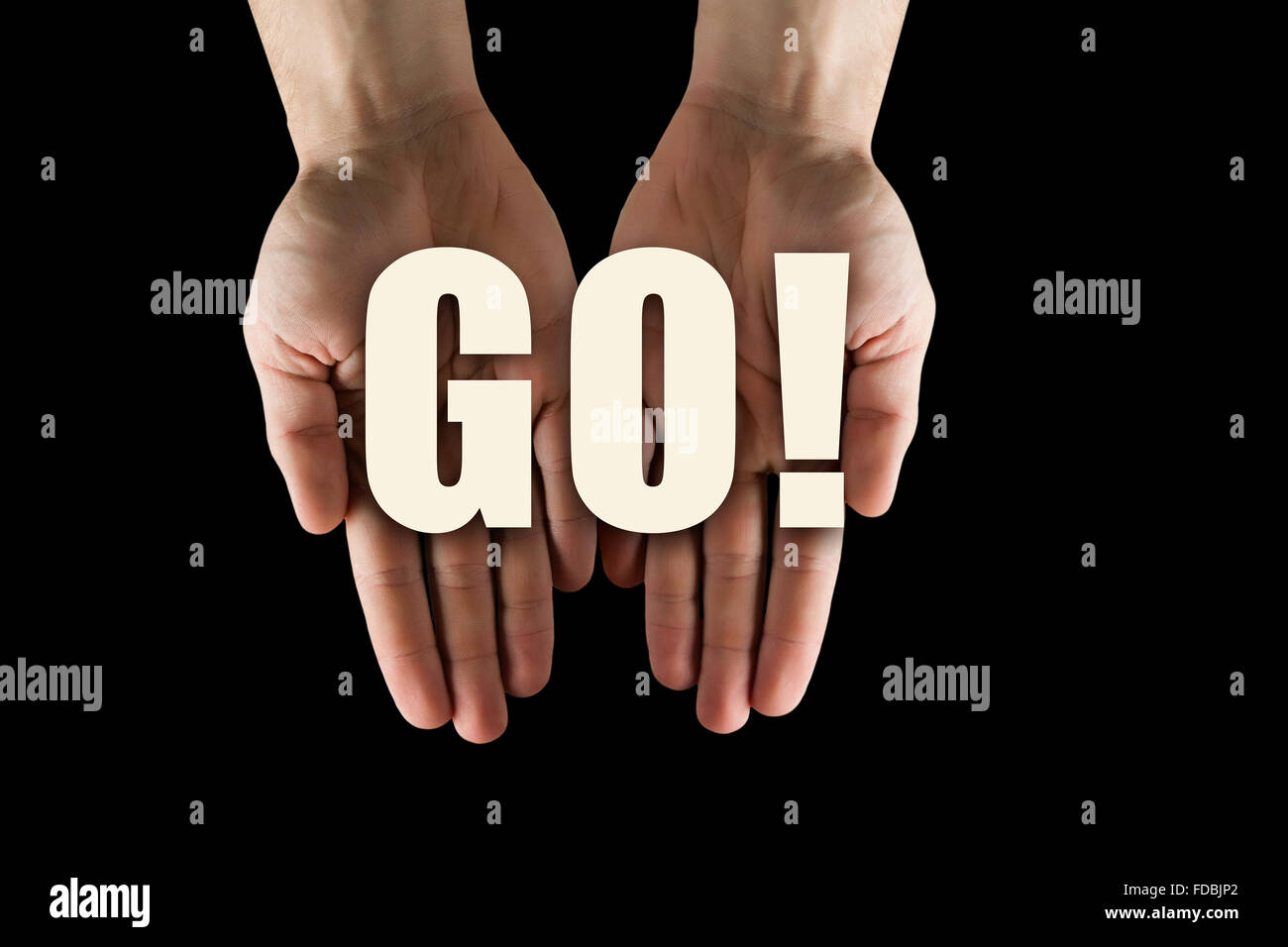 Male hands on dark background showing in palms word GO Stock Photo - Alamy
