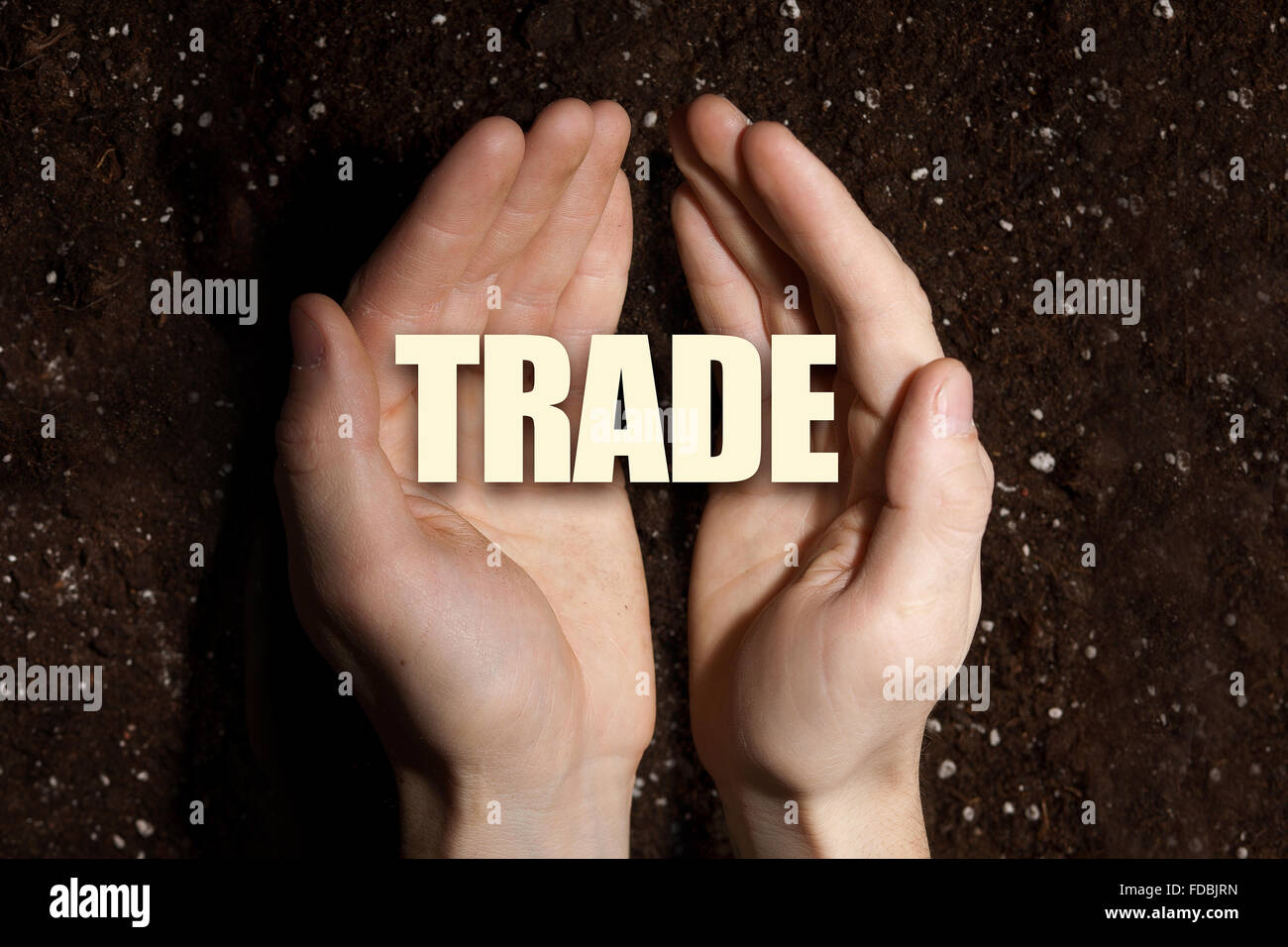 Male hands on soil background showing in palms word trade Stock Photo ...