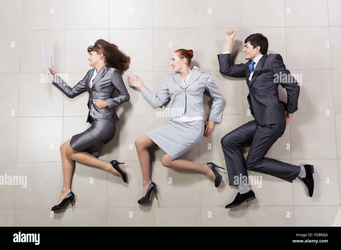 Young people in business suits lying on floor Stock Photo - Alamy