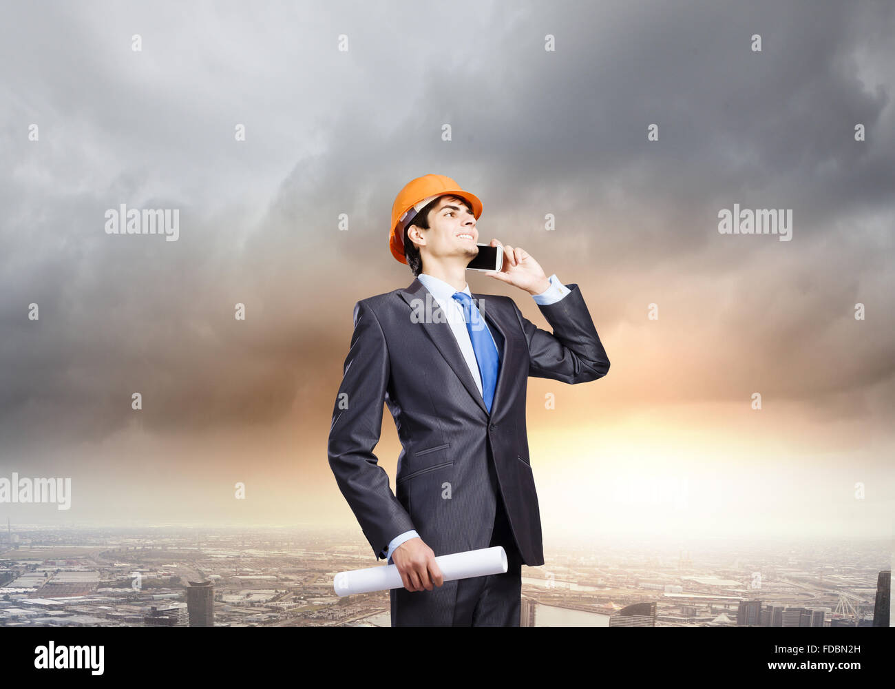 Young man engineer talking on mobile phone Stock Photo - Alamy