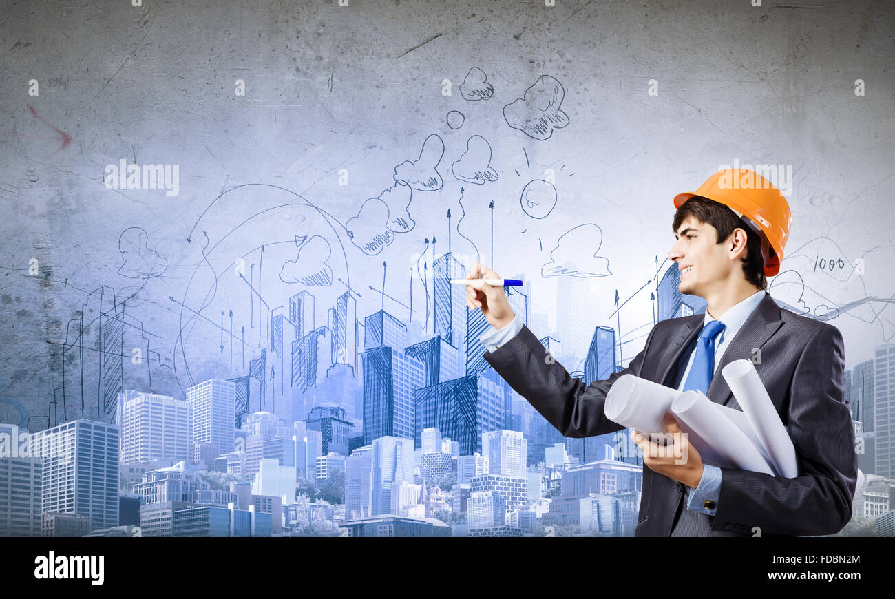 Young man engineer drawing sketches of construction project Stock Photo ...